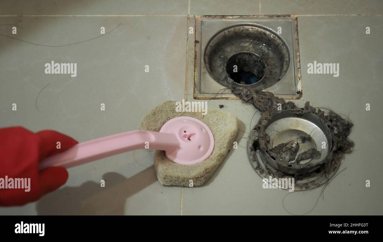Drain cleaning. Clogged and dirty sewer pipes floor drain. Full of hair ...