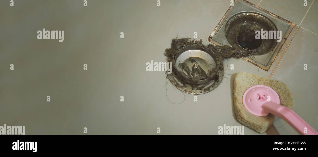 Drain cleaning. Clogged and dirty sewer pipes floor drain. Full of hair ...