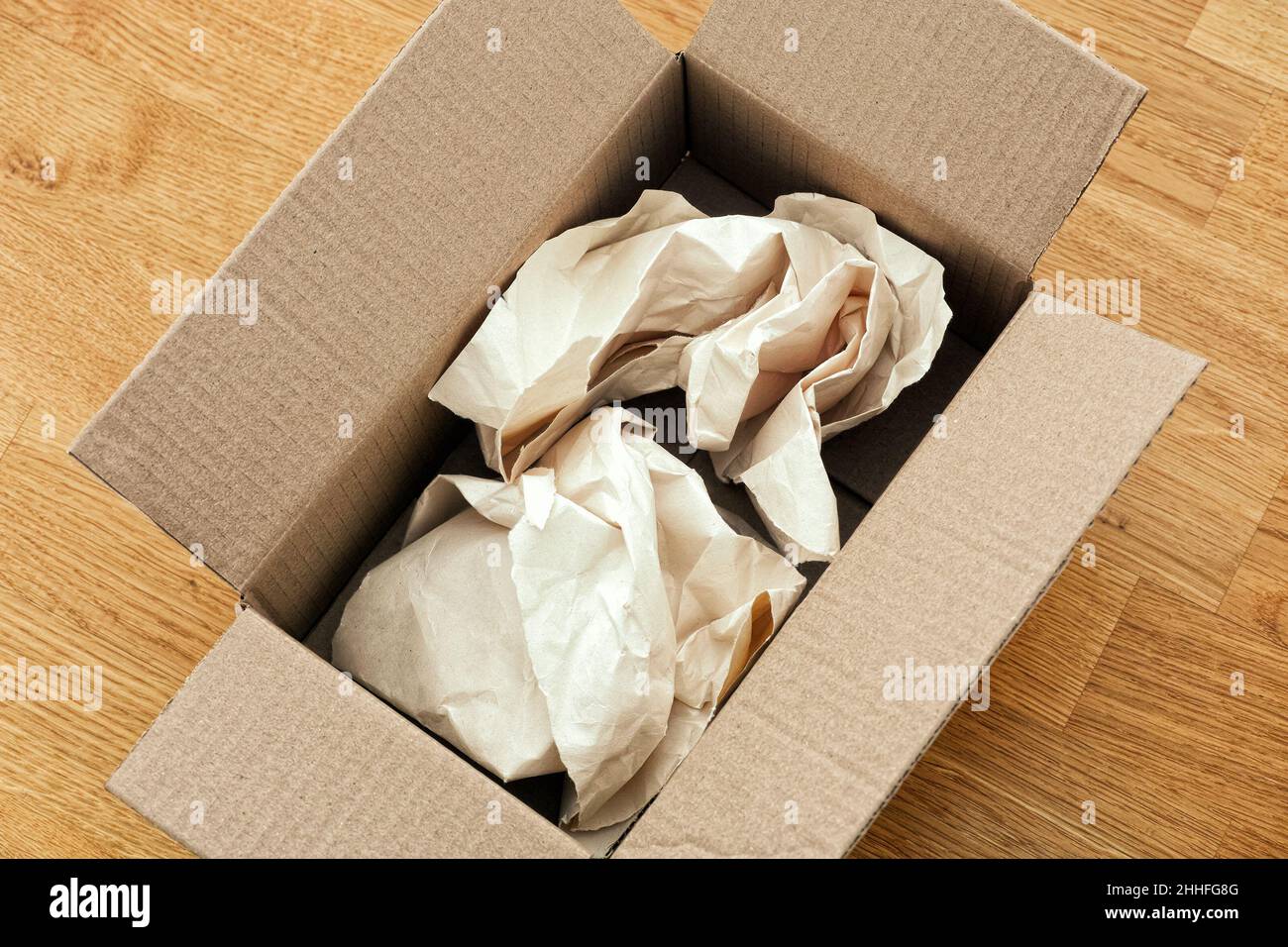 Crumpled paper in a cardboard box. Close up Stock Photo - Alamy