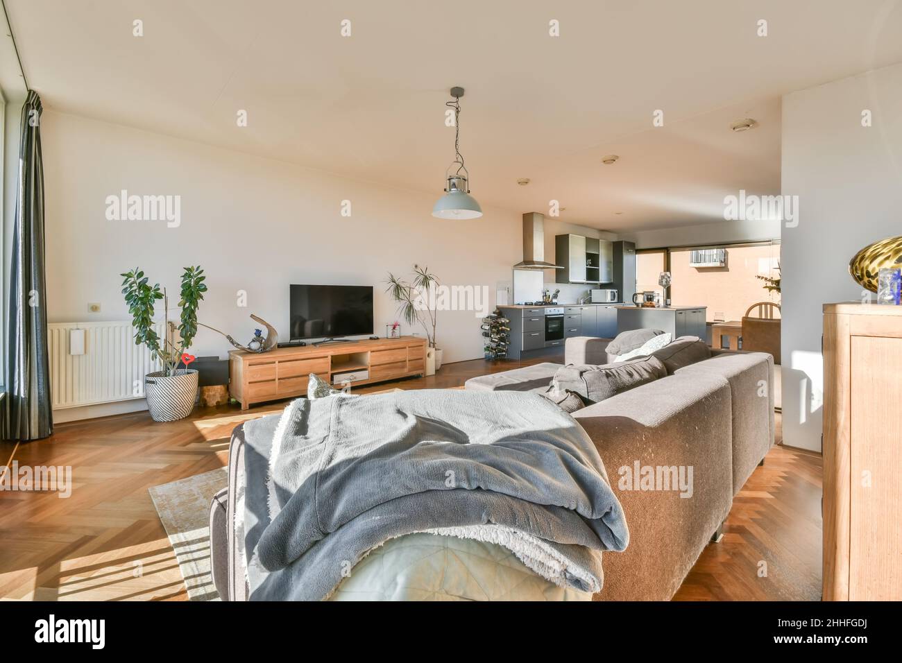 Stylish and cozy living room with soft decorative huge sofa Stock Photo ...