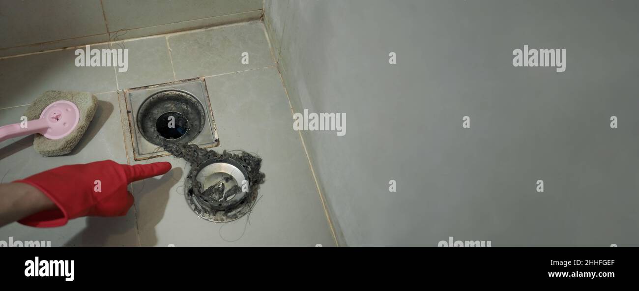 Drain cleaning. Clogged and dirty sewer pipes floor drain. Full of hair ...