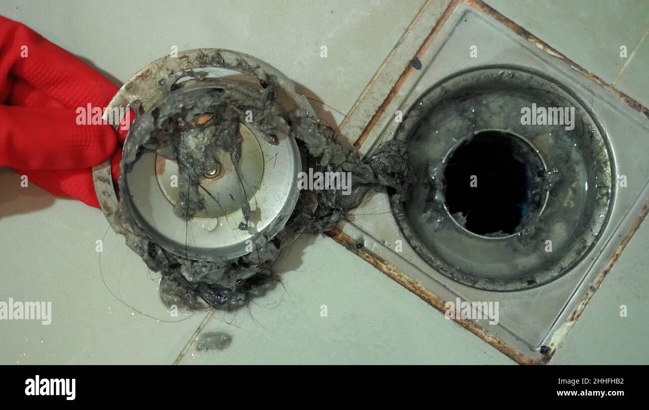 Drain cleaning. Clogged and dirty sewer pipes floor drain. Full of hair ...