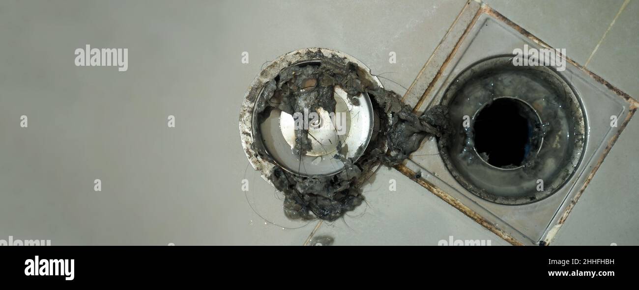 Drain cleaning. Clogged and dirty sewer pipes floor drain. Full of hair ...