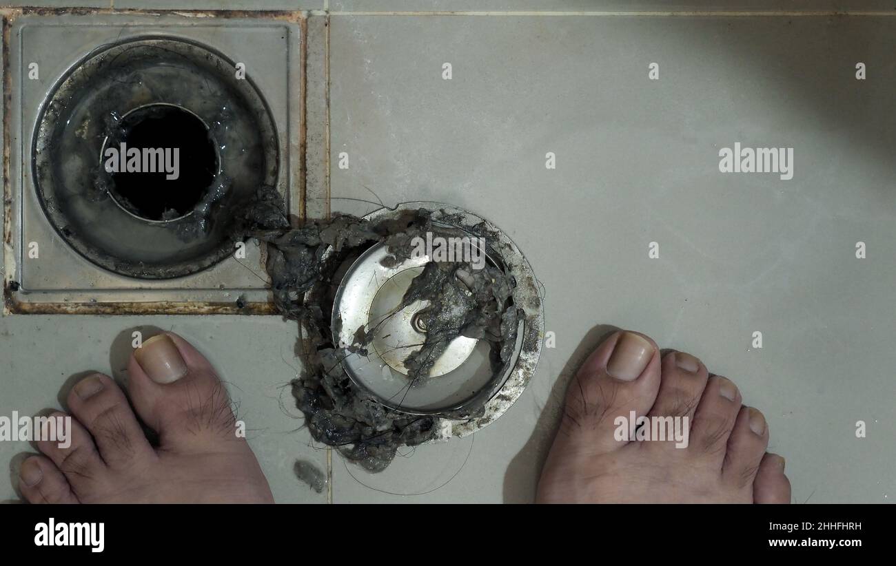 Drain cleaning. Clogged and dirty sewer pipes floor drain. Full of hair ...