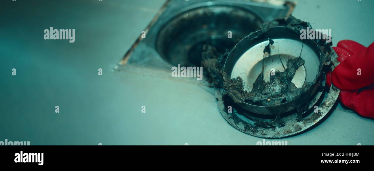 Drain cleaning. Clogged and dirty sewer pipes floor drain. Full of hair ...