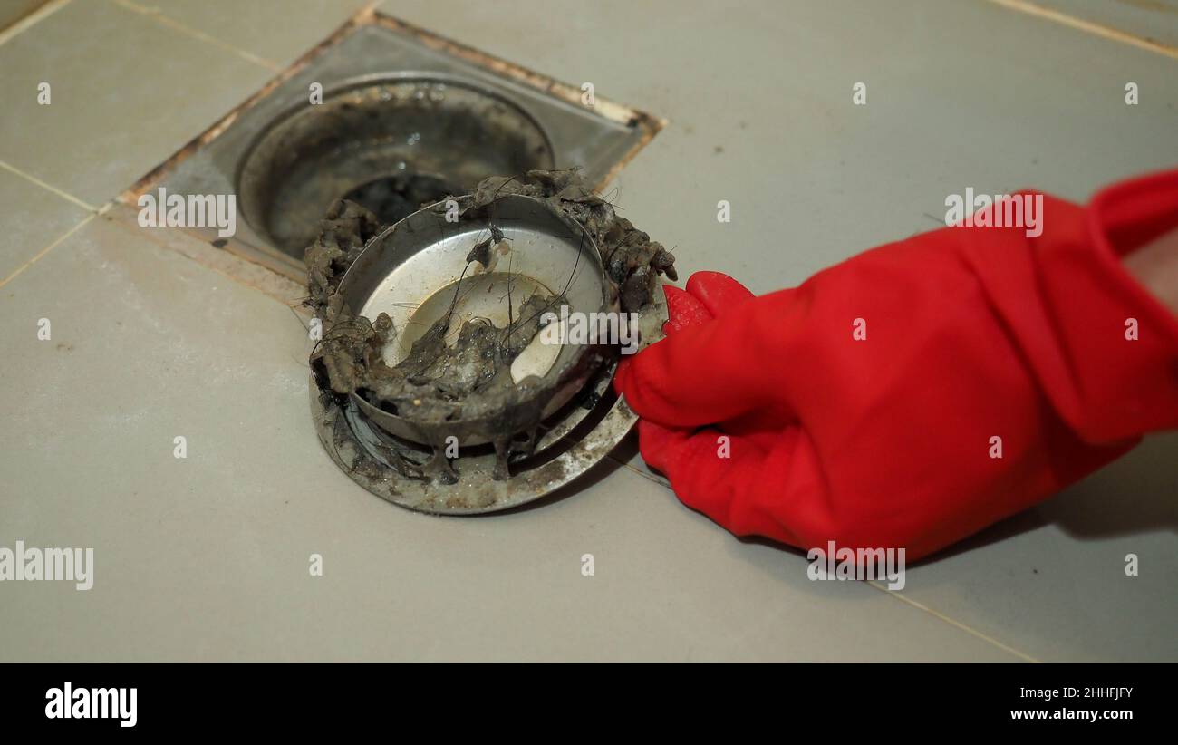 Drain cleaning. Clogged and dirty sewer pipes floor drain. Full of hair ...