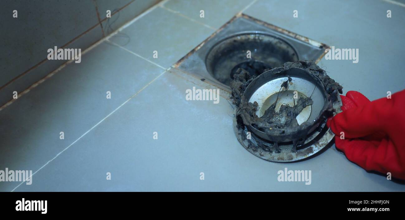 Drain cleaning. Clogged and dirty sewer pipes floor drain. Full of hair ...