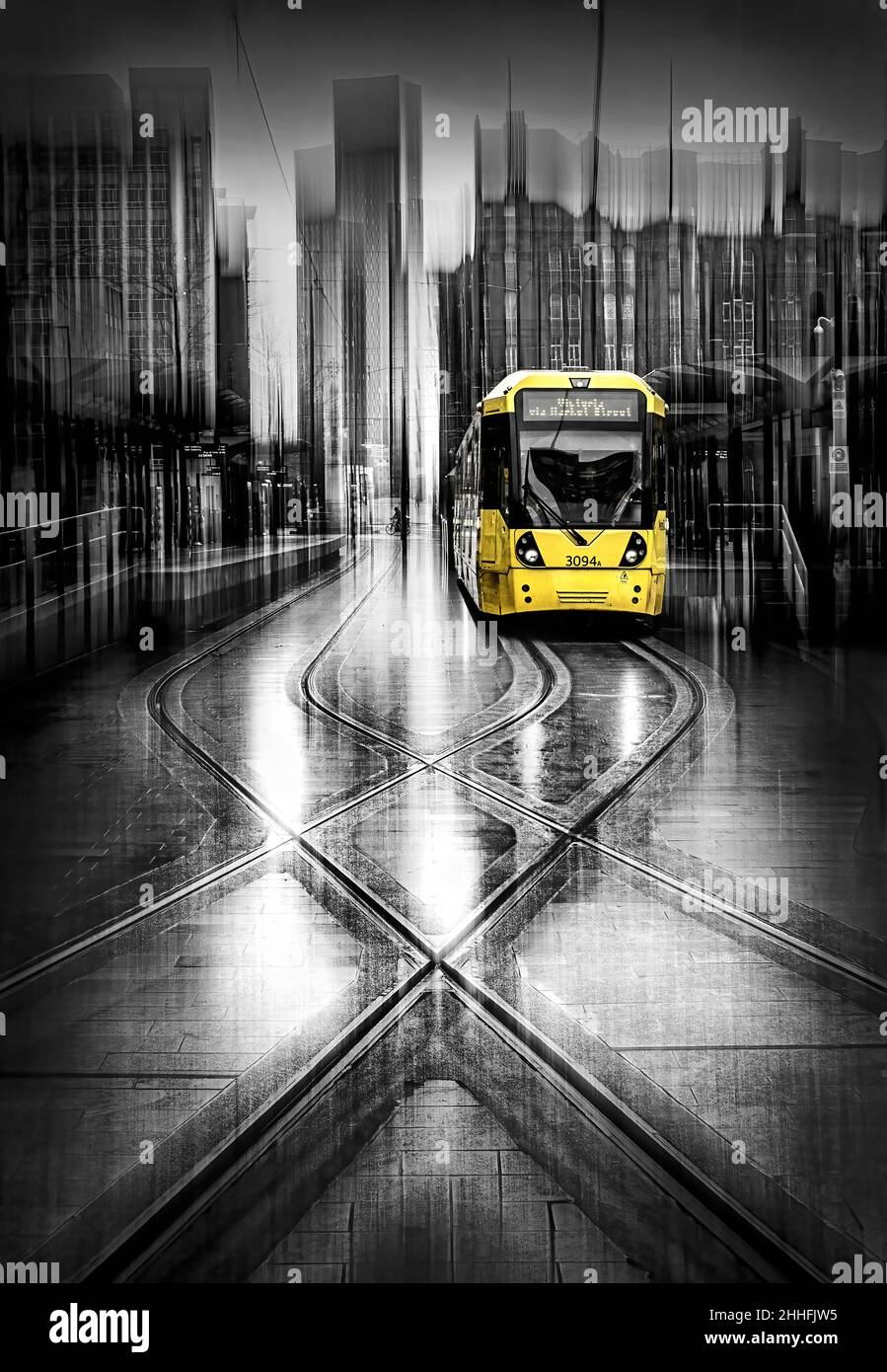 Yellow Tram at a Stop in Manchester with ICM Stock Photo - Alamy