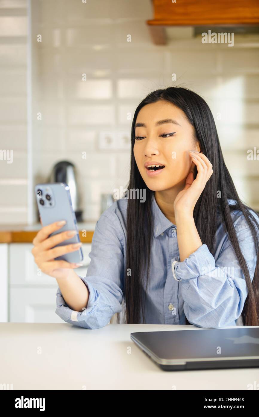 Beautiful young asian woman talking on video phone call. Pretty girl ...