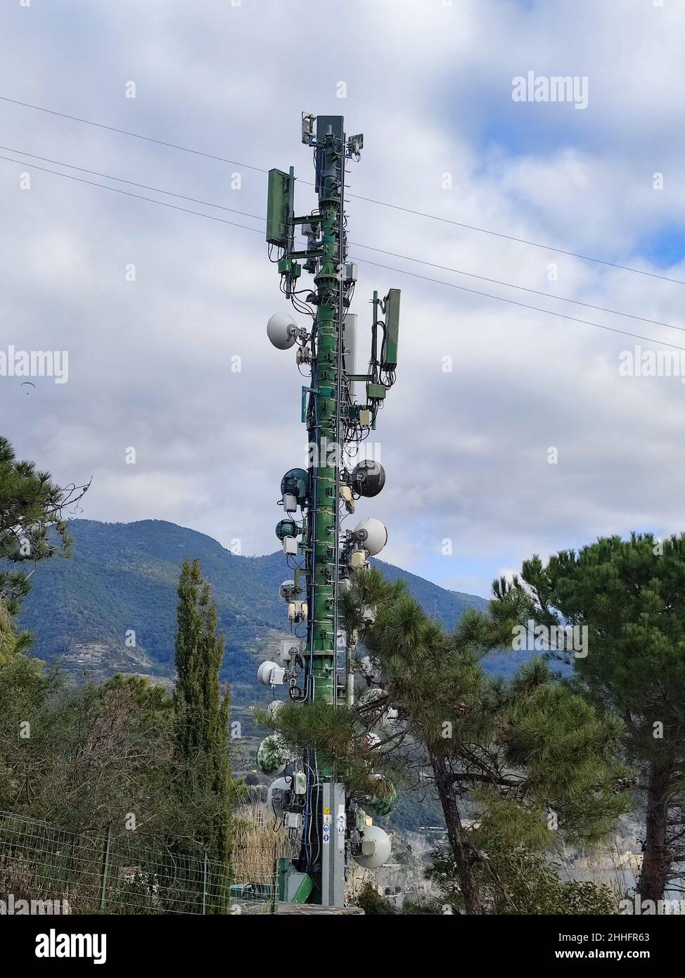 Communication cellular mobile green antenna in italy Stock Photo - Alamy