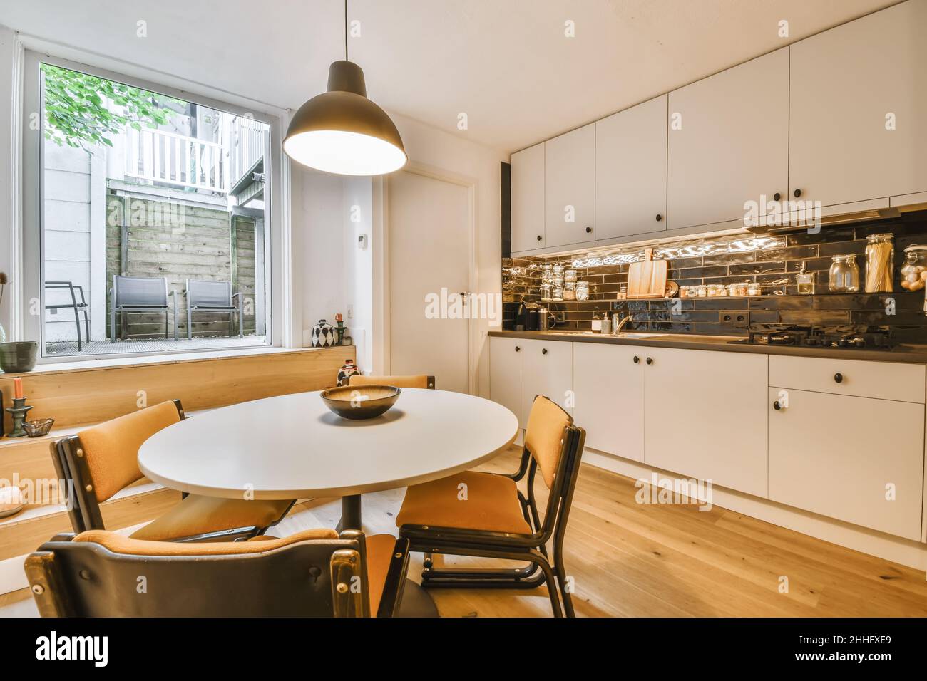Adorable small dining area with round table combined with kitchen Stock ...