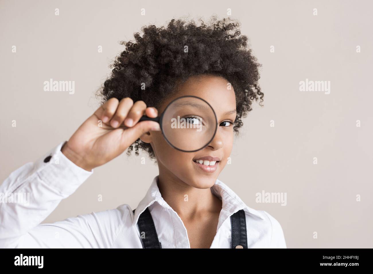 Little girl looking through magnifying glass. Funny child islolated ...