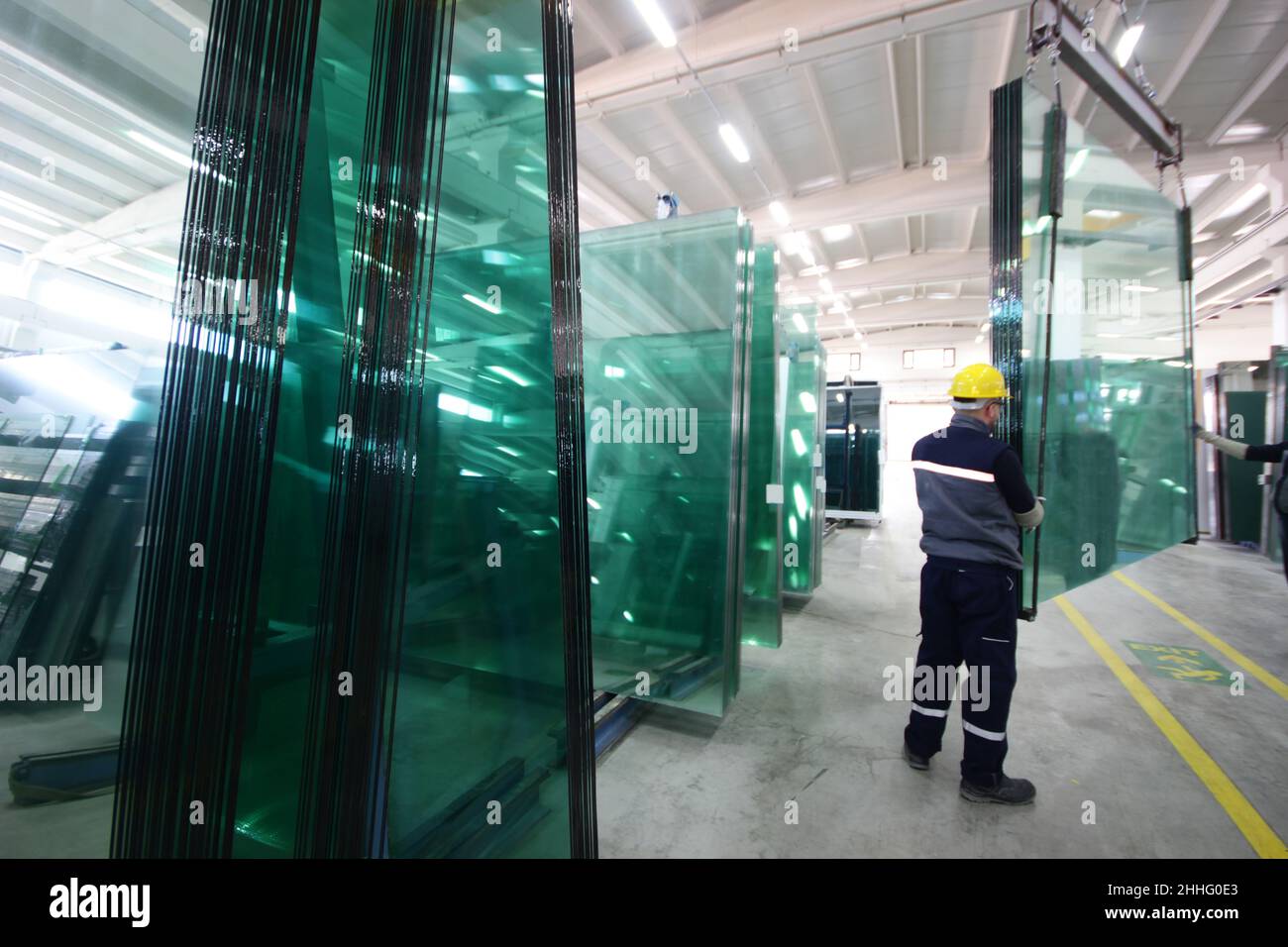 Construction workers carrying window hi-res stock photography and ...