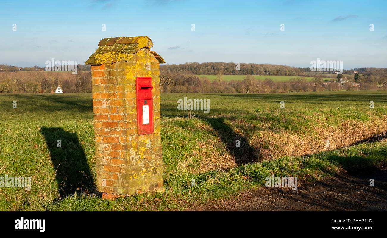 A post box mounted in a custom built brick tower with small tiled roof ...