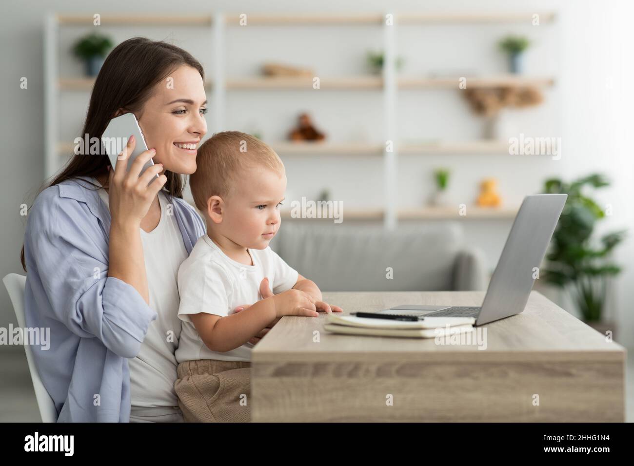 Multitasking Concept. Working Mom Talking On Cellphone And Holding ...