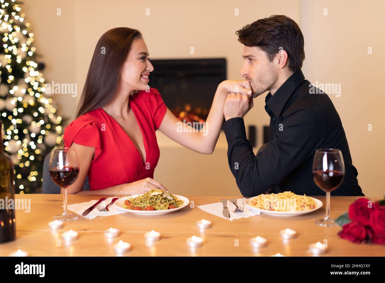 Romantic young man kissing his beloved woman's hands Stock Photo - Alamy