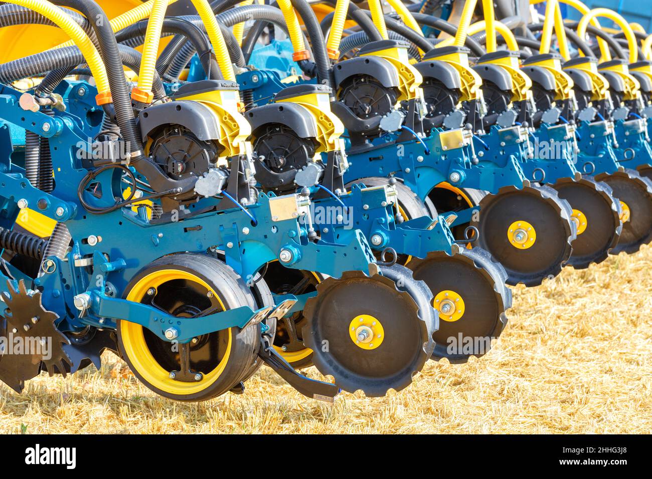 A fragment of the wheel mechanism of a multi-row seeder against the ...