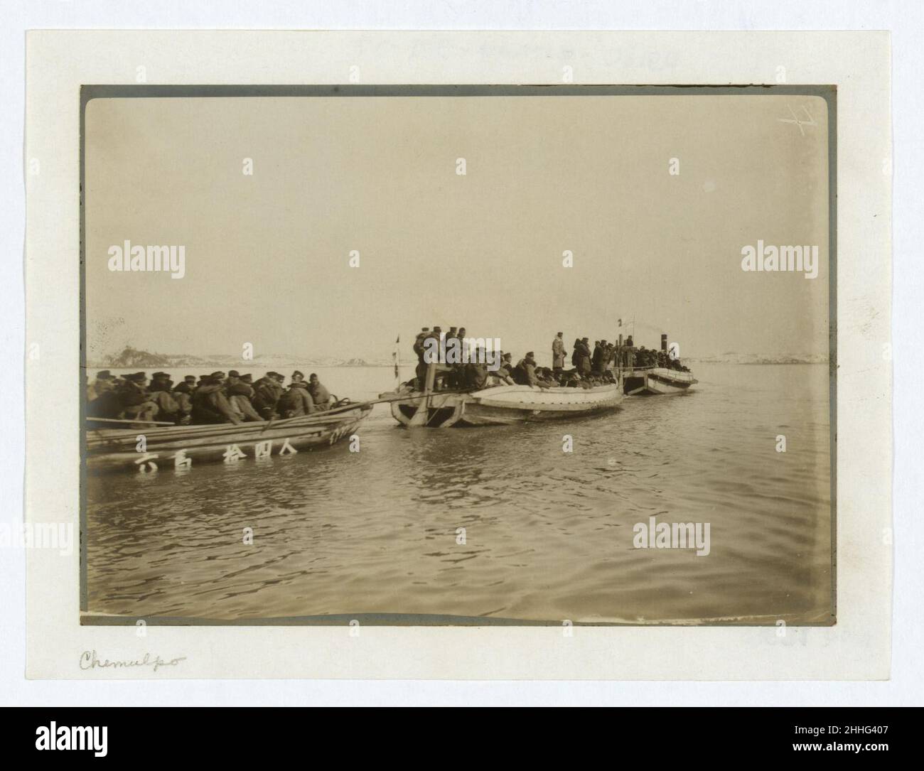 Steam launch carrying six over-crowded boat loads soldiers to landing ...