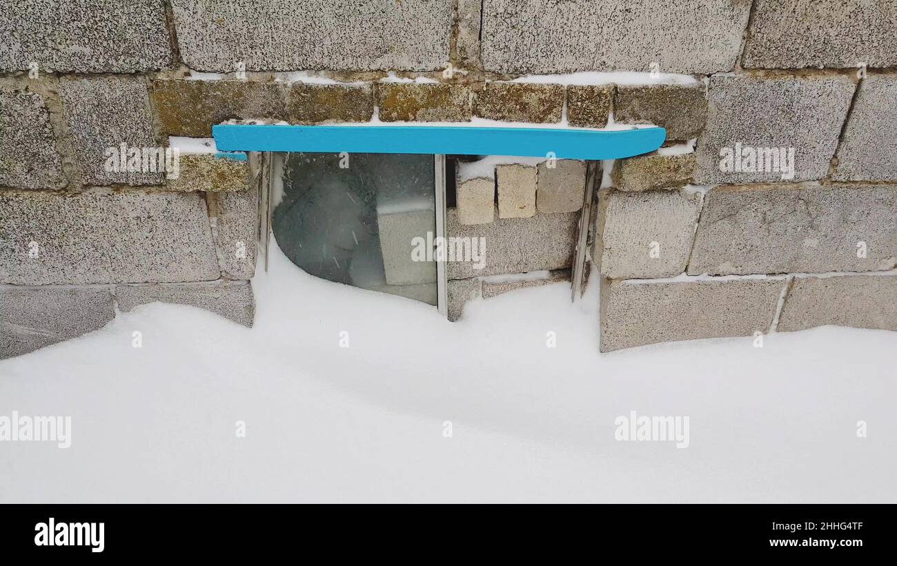 bricks and cinder blocks from the bus window on the front wall with ...