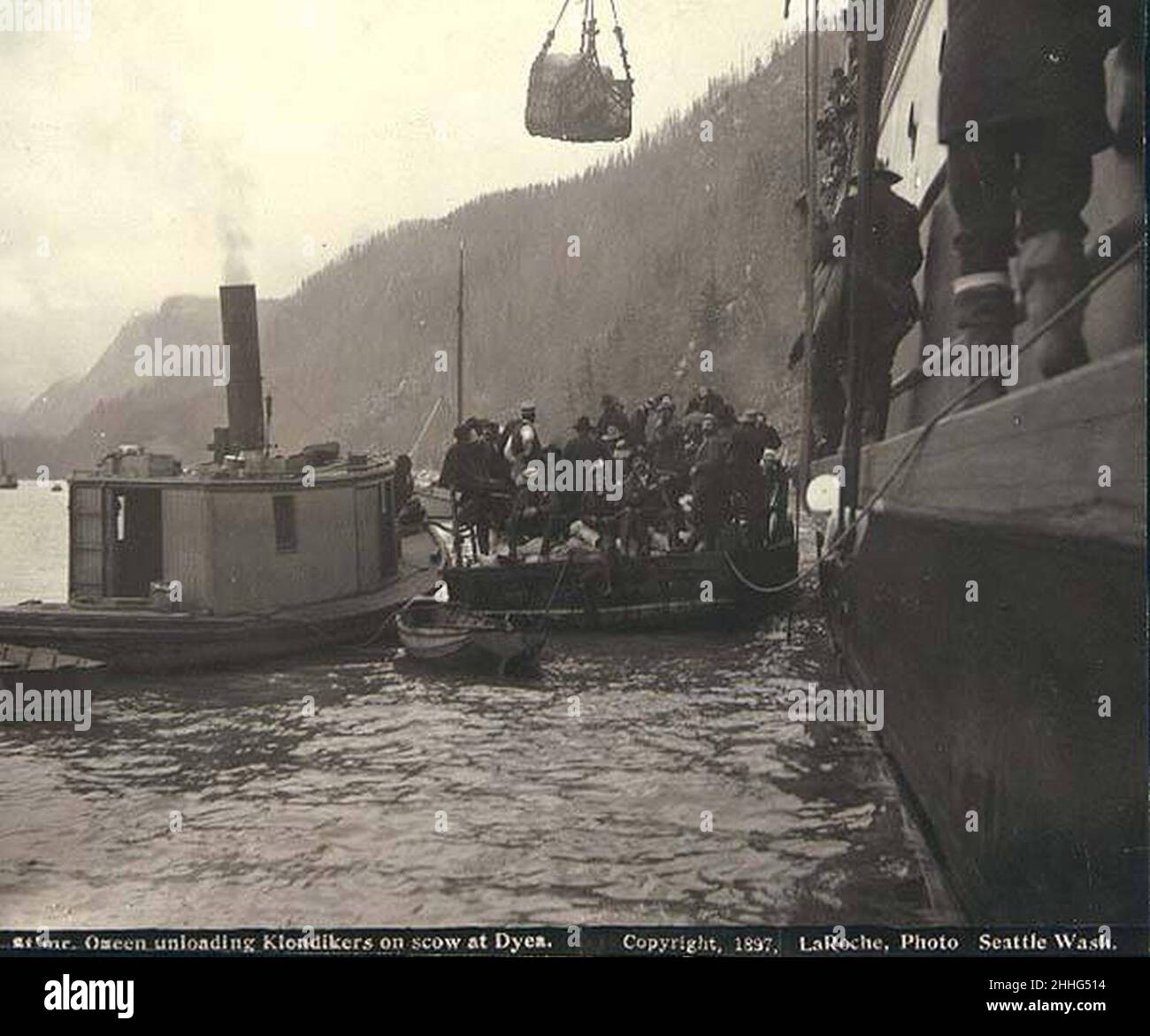 Steamer QUEEN unloading Klondikers and supplies on to a scow in Dyea ...