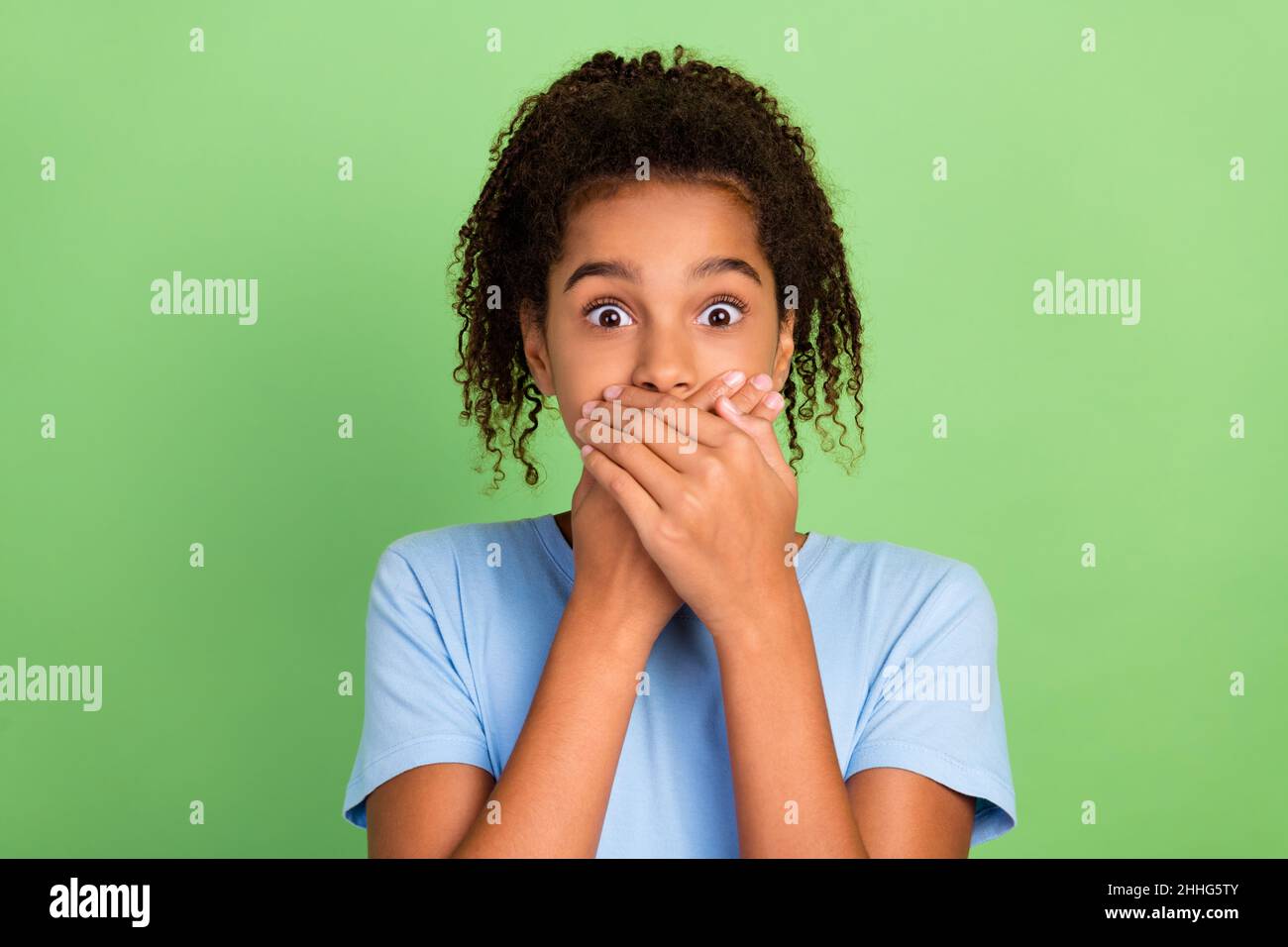 Photo of young black preteen girl cover mouth hands scared mute oops ...