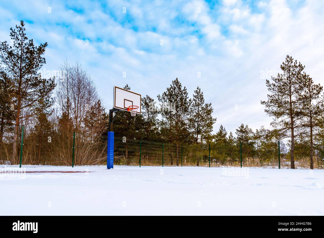 Basketball field covered with snow. Outdoor basketball court in winter ...
