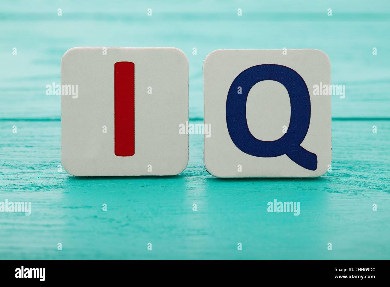 Intelligence quotient. Word IQ on blue wooden background. Copy space ...