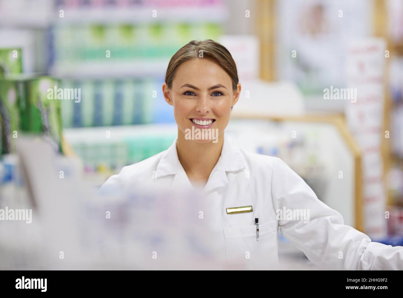Assisting you with your medicinal needs. Portrait of an attractive young pharmacist at work ...