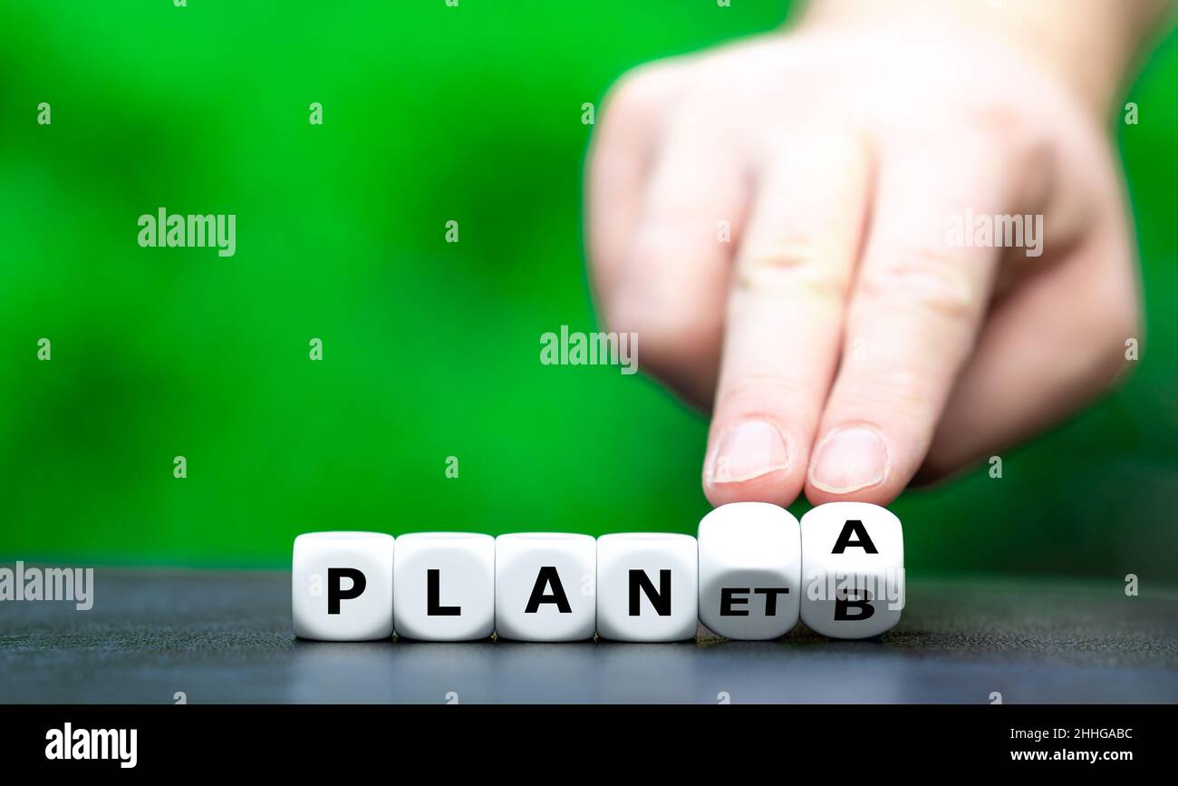 Symbol to fight against climate change. Hand turns dice and changes the ...