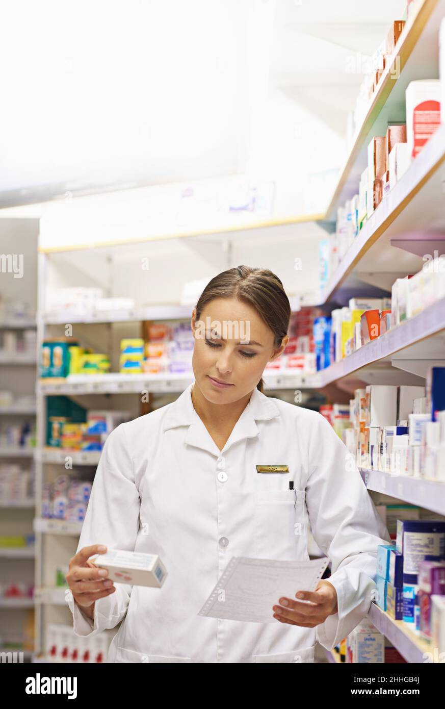 Checking and double-checking. Shot of an attractive young pharmacist ...