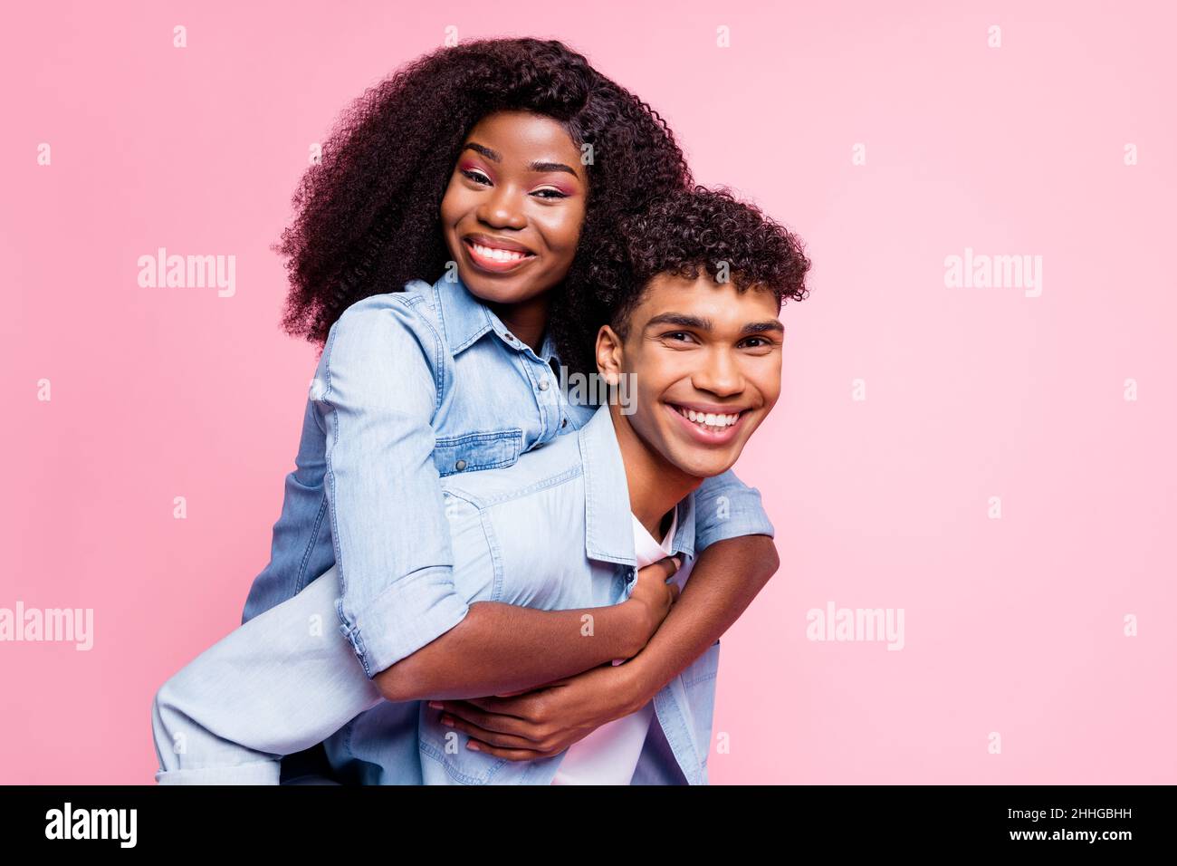 Photo of handsome dark skin guy piggyback attractive lady toothy smile ...