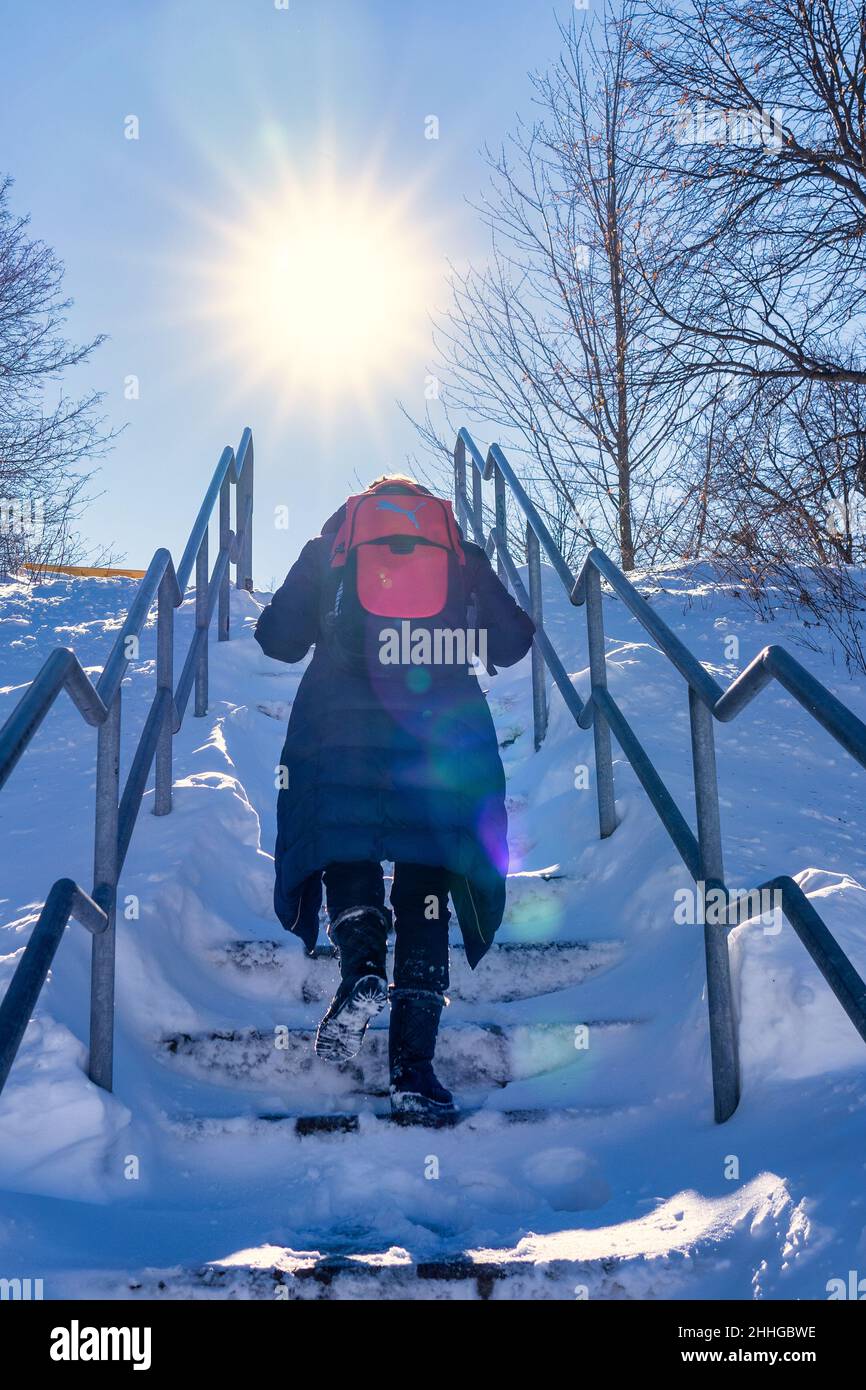 Hispanic woman running errands in the city after a heavy snowfall ...
