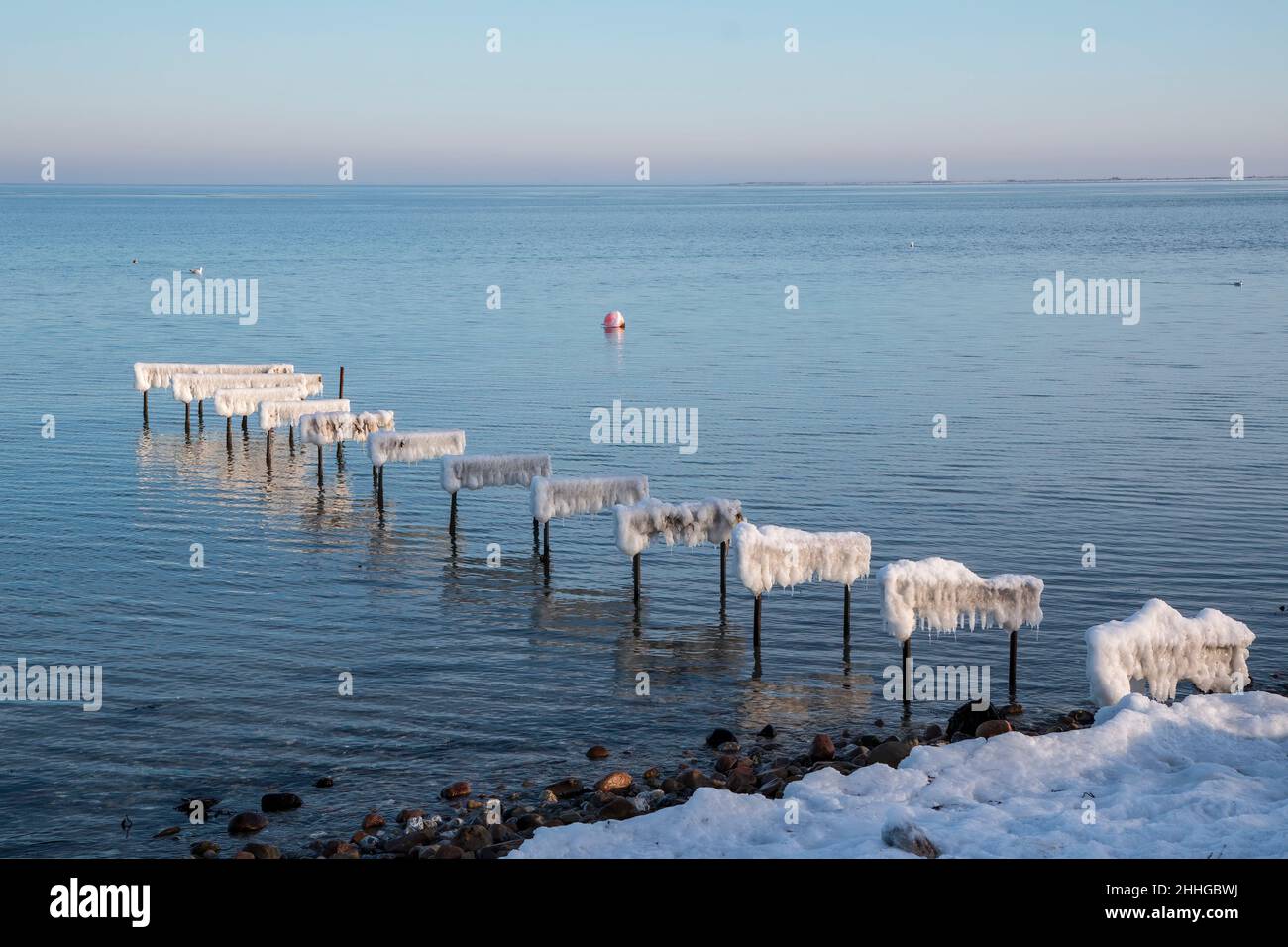 Ice on posts used for a small bathing jetty Stock Photo - Alamy