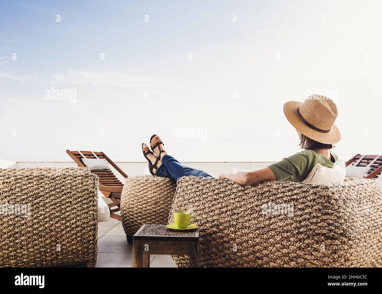 Young woman resting on hotel terrace. Vacations, travel, tourism ...