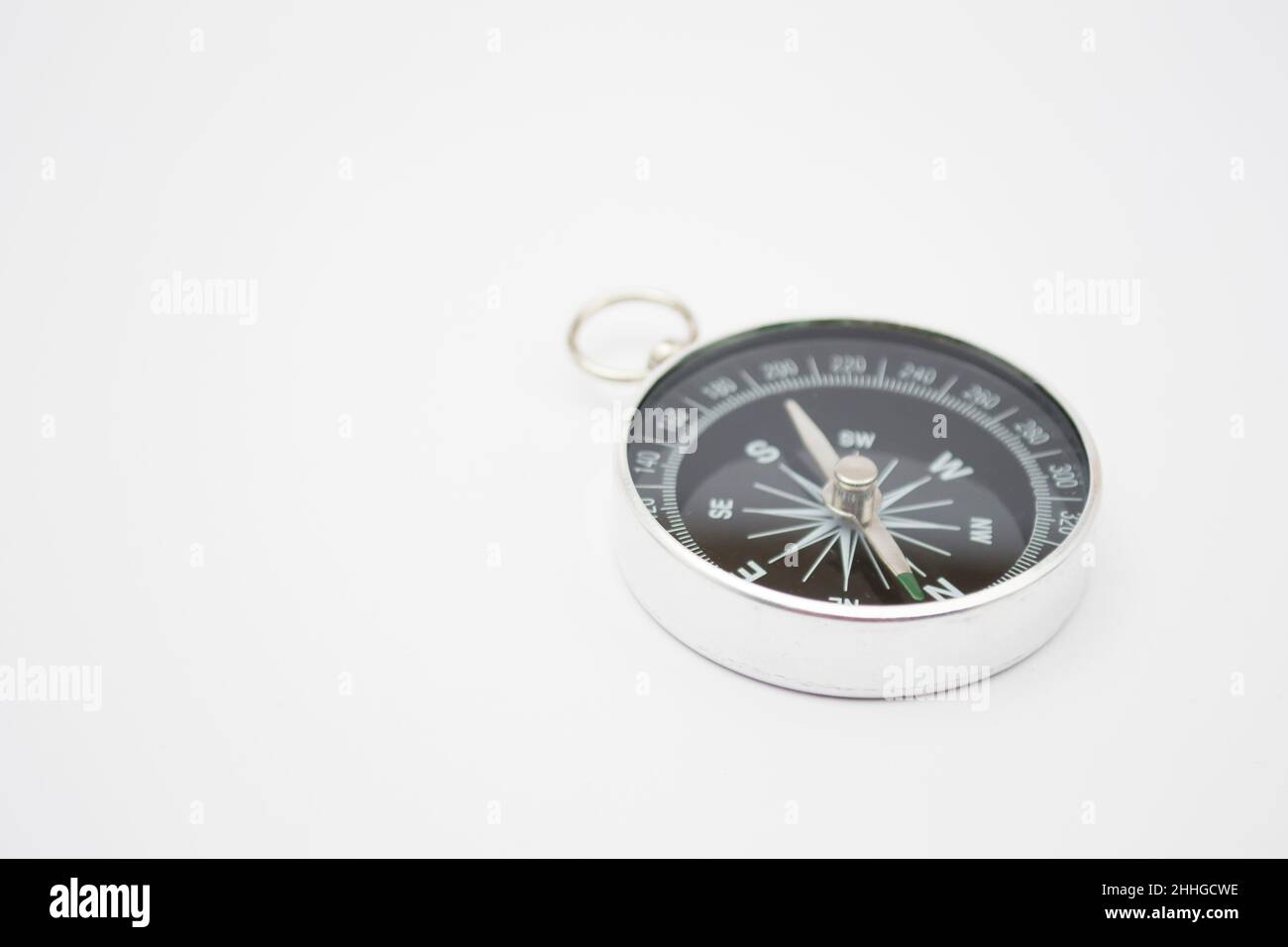 Compass at isolated white background Stock Photo - Alamy