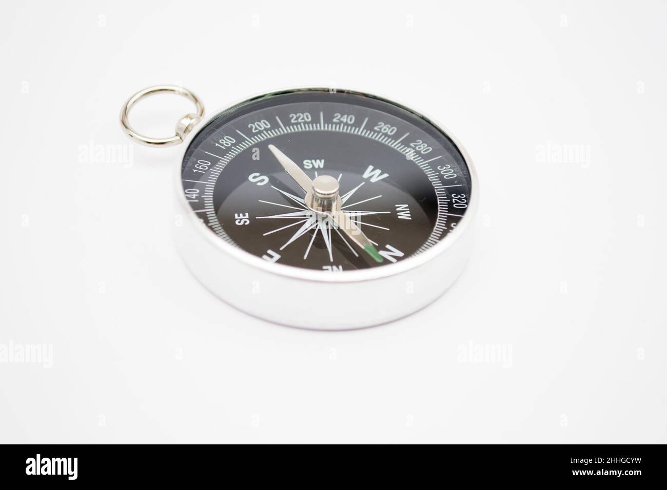 Compass at isolated white background Stock Photo - Alamy