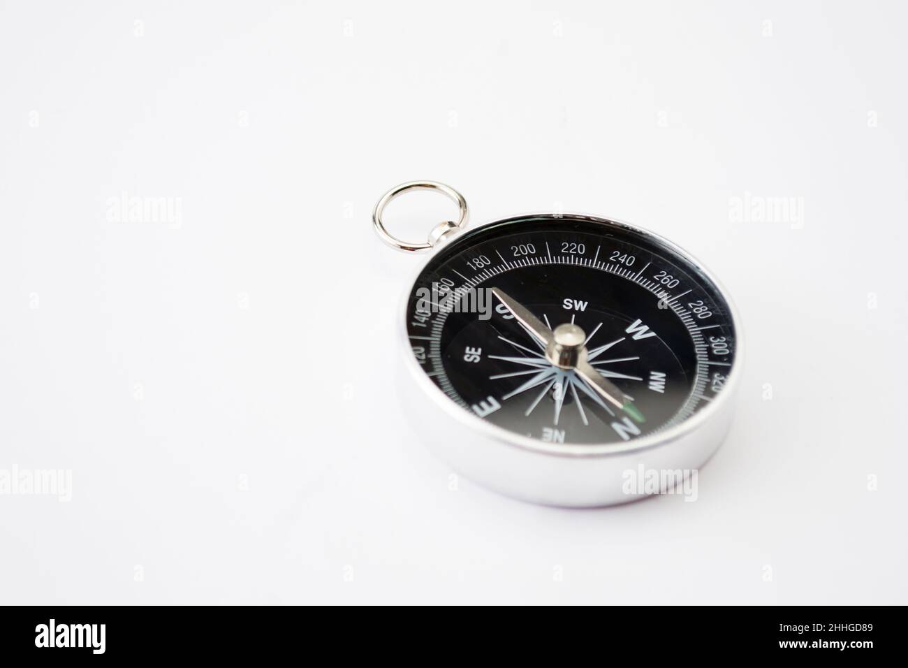 Compass at isolated white background Stock Photo - Alamy
