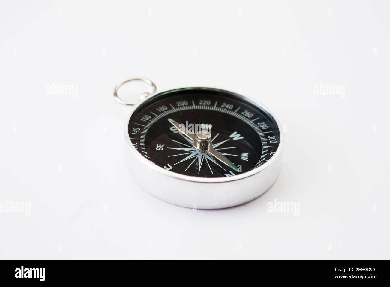 Compass at isolated white background Stock Photo - Alamy