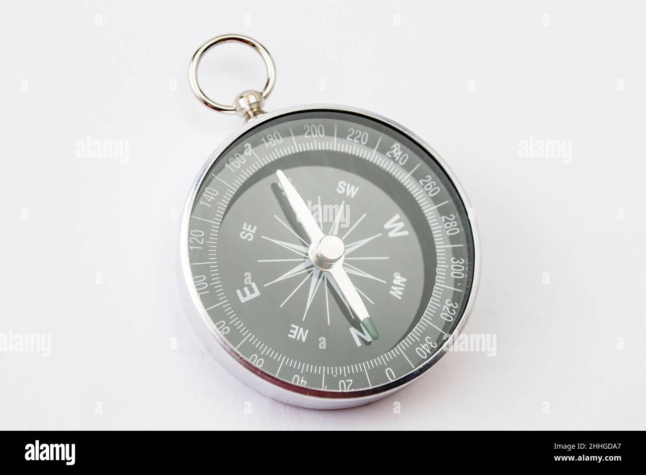 Compass at isolated white background Stock Photo - Alamy