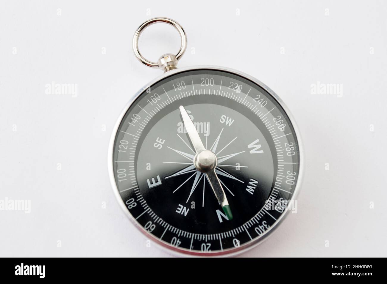 Compass at isolated white background Stock Photo - Alamy