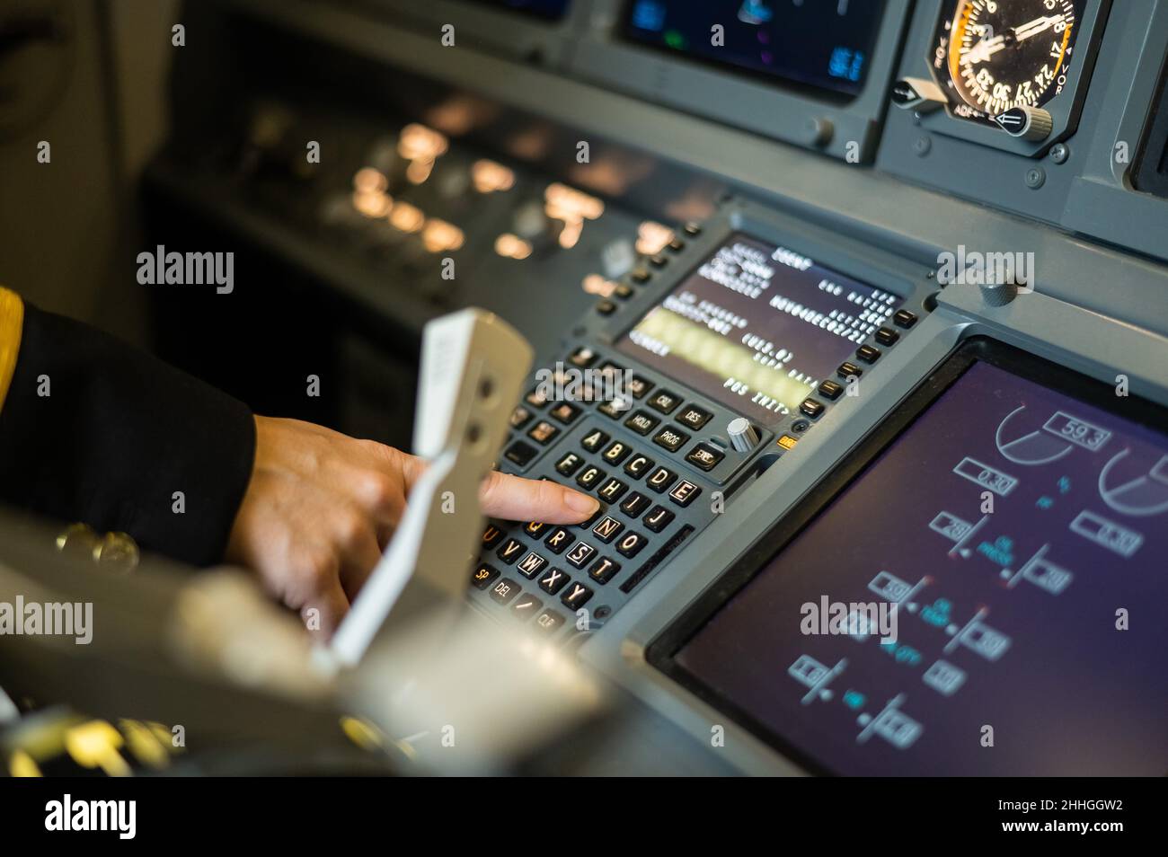 Female pilot inserting flight information into plane system. Airplane ...