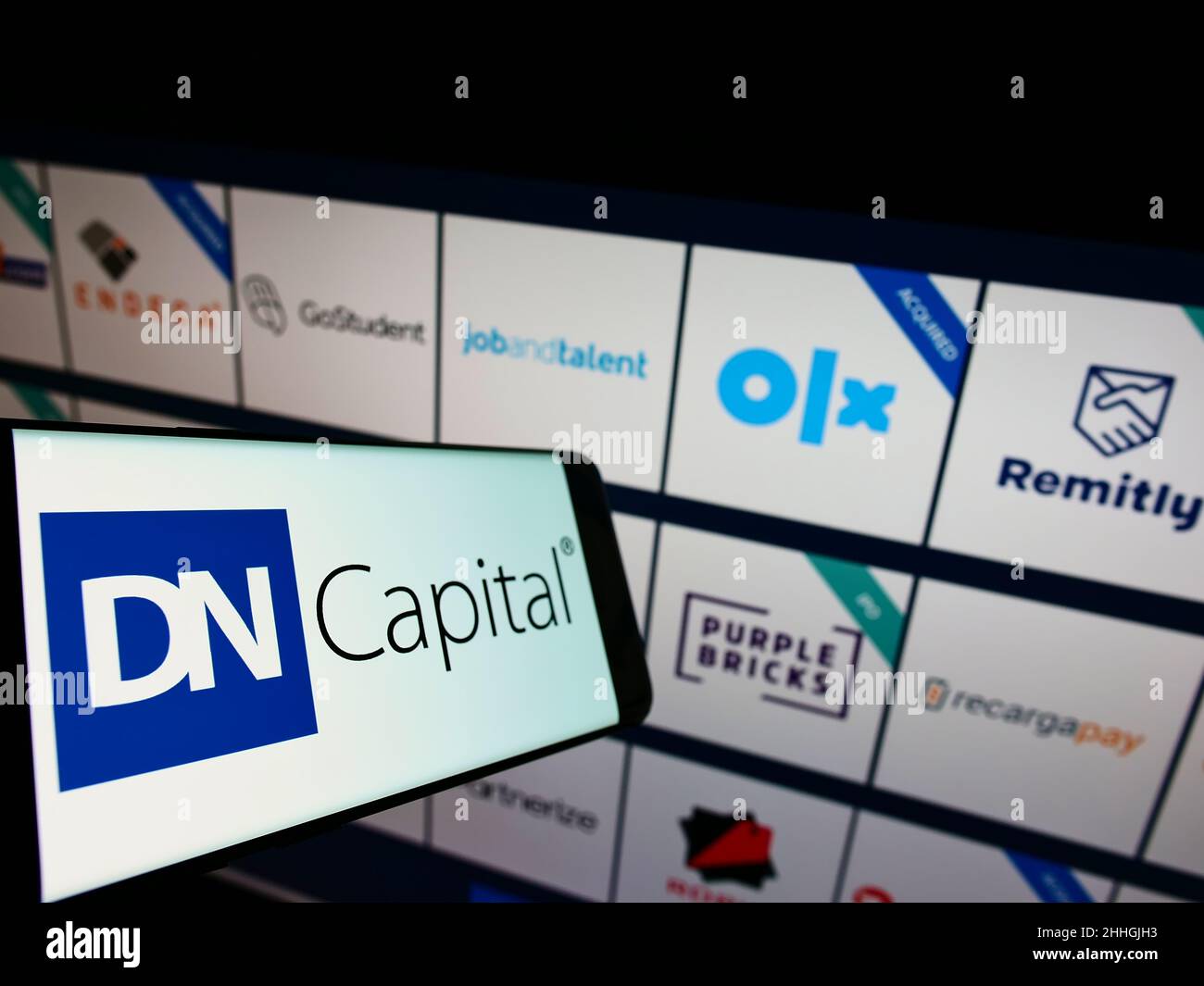 Cellphone with logo of British investment company DN Capital on screen ...