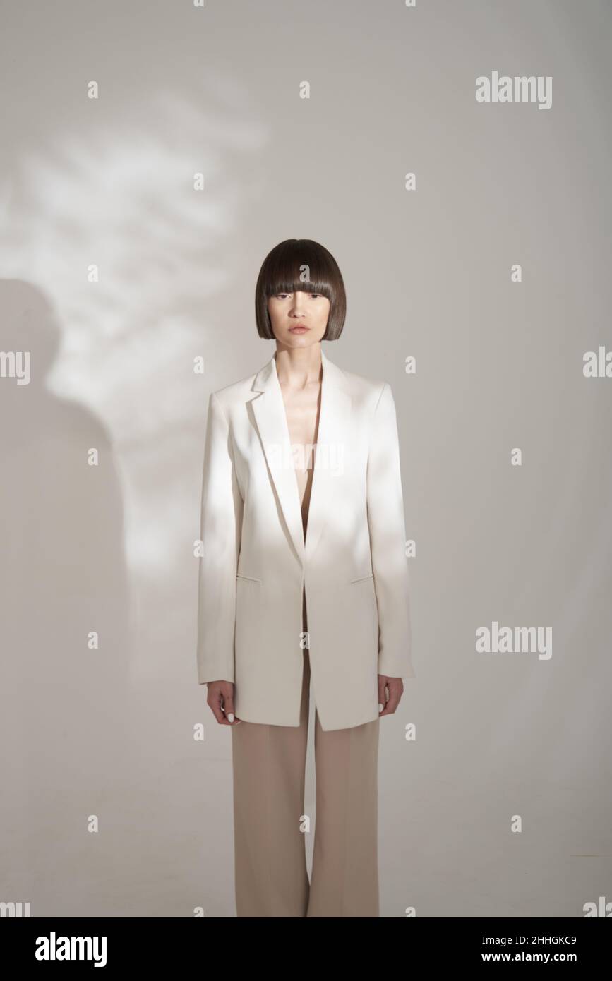 Beautiful brunette woman with natural makeup wear fashion pantsuit ...