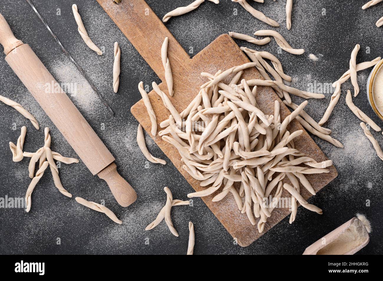 Whole grain wheat apulian pasta Pizzarieddi or maccaruni on a cutting ...
