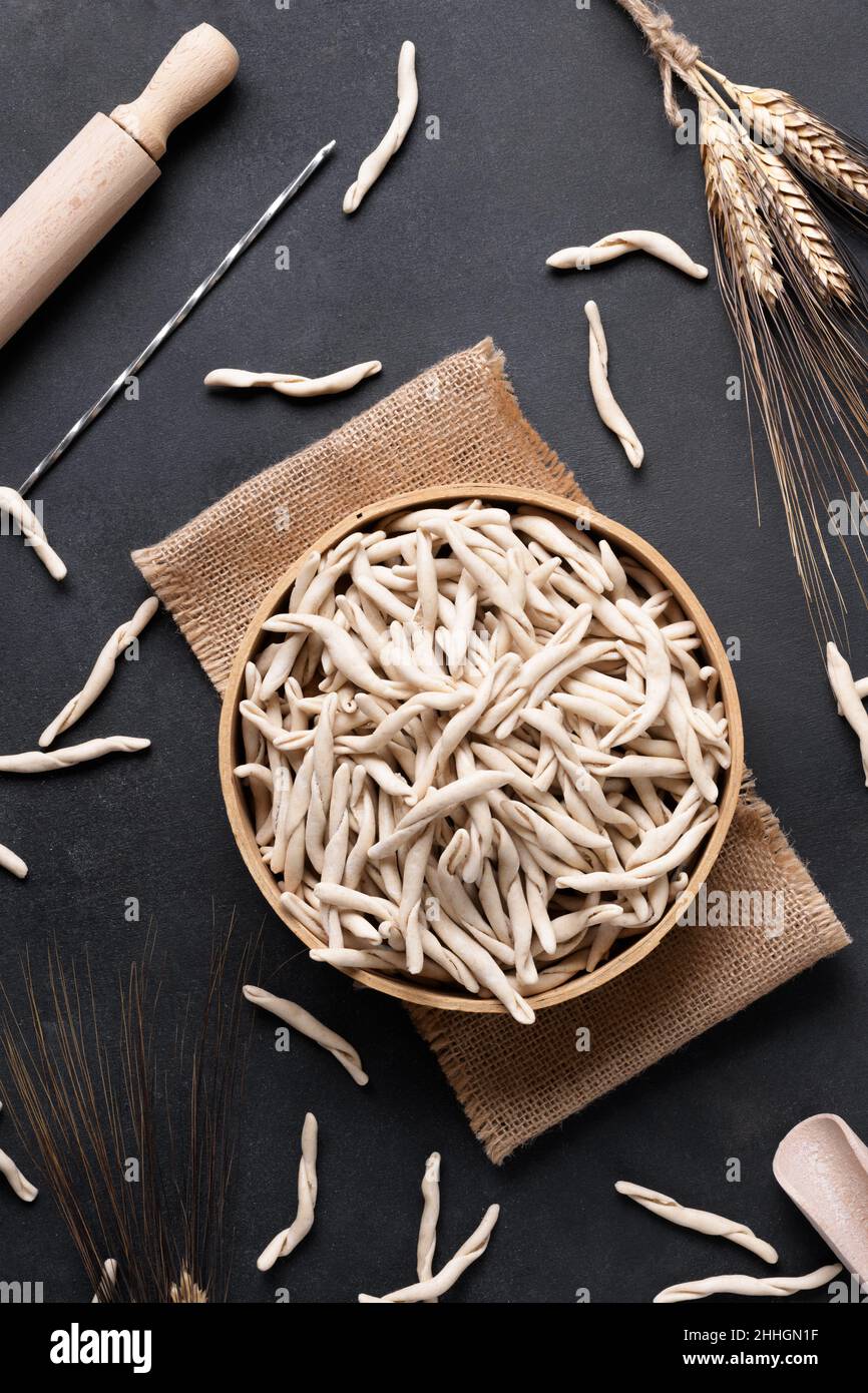 Whole grain wheat apulian pasta Pizzarieddi or maccaruni in a sieve on ...