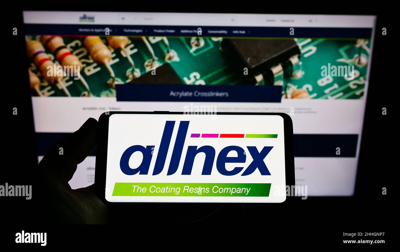 Person holding smartphone with logo of German chemicals company Allnex ...