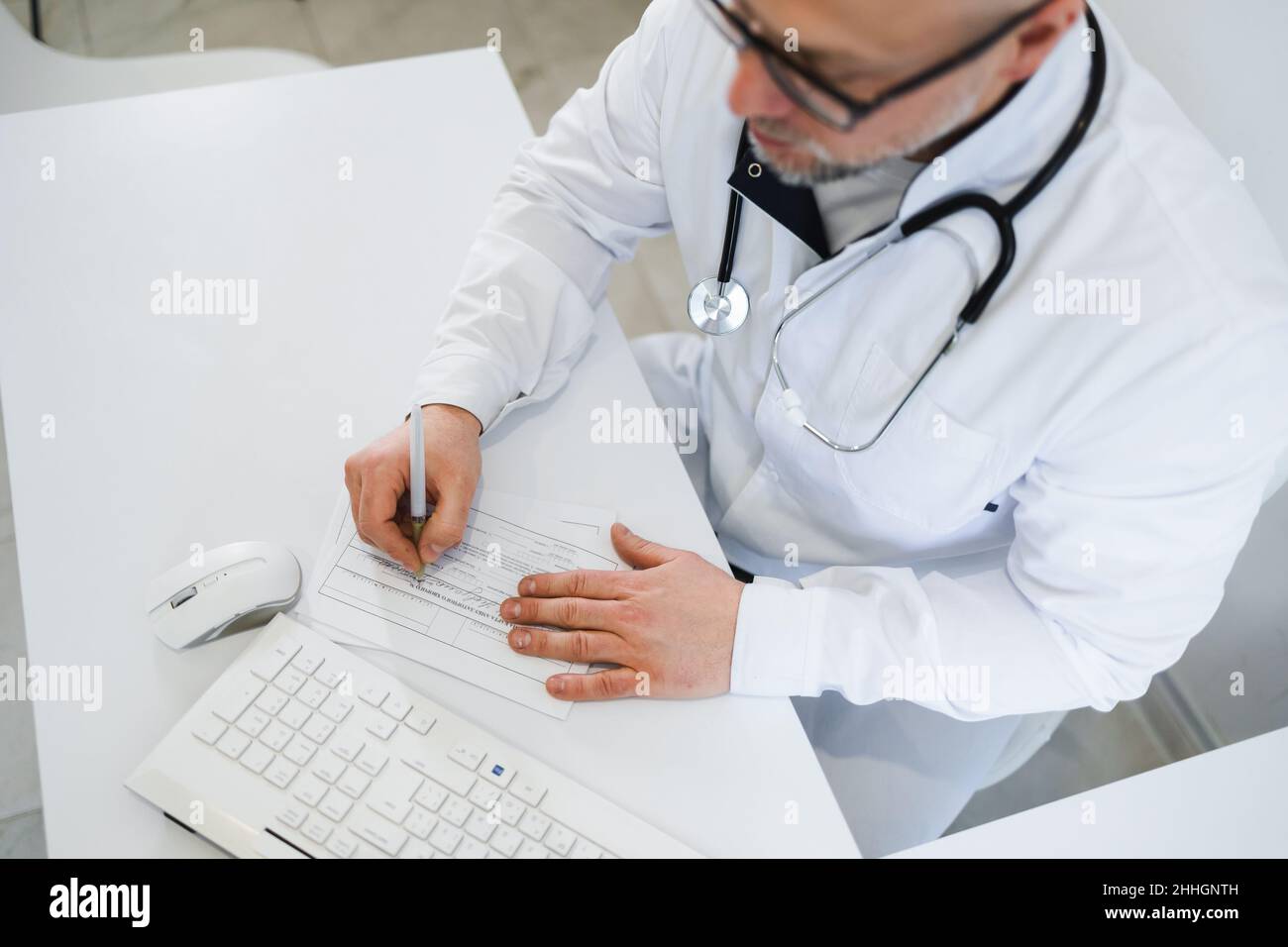 Top view doctor writes out a prescription for a patient. Therapist ...