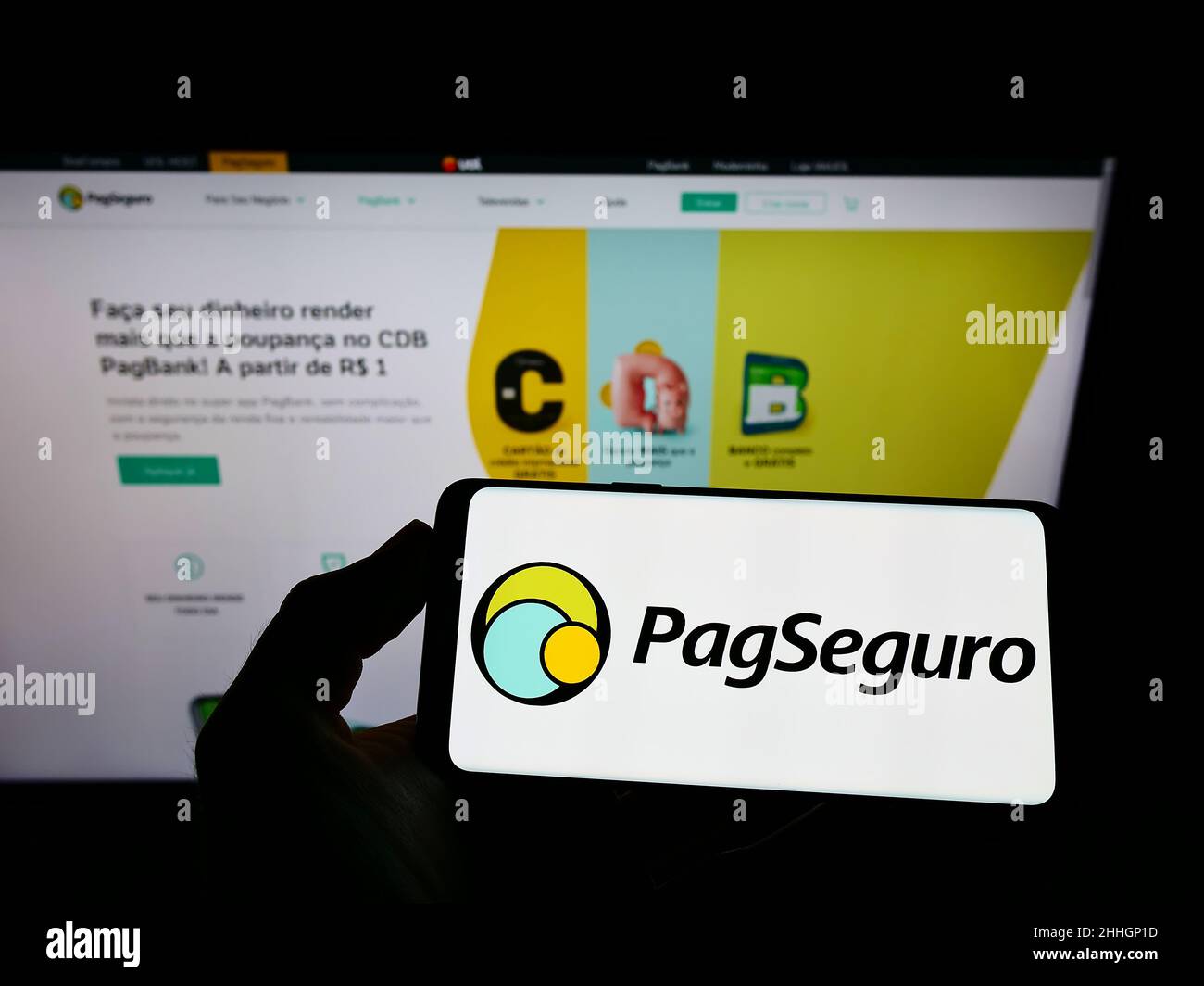 Person holding cellphone with logo of Brazilian fintech company ...