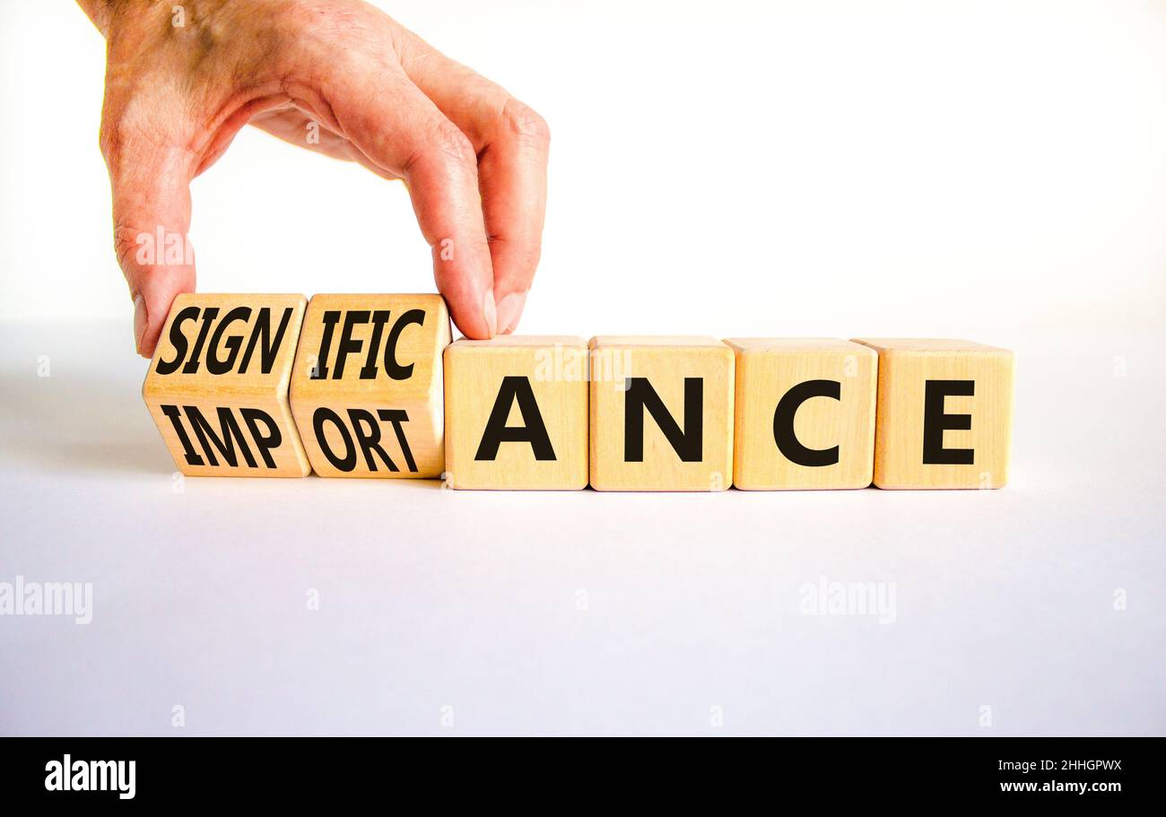 Significance and importance symbol. Businessman turns cubes changes the ...