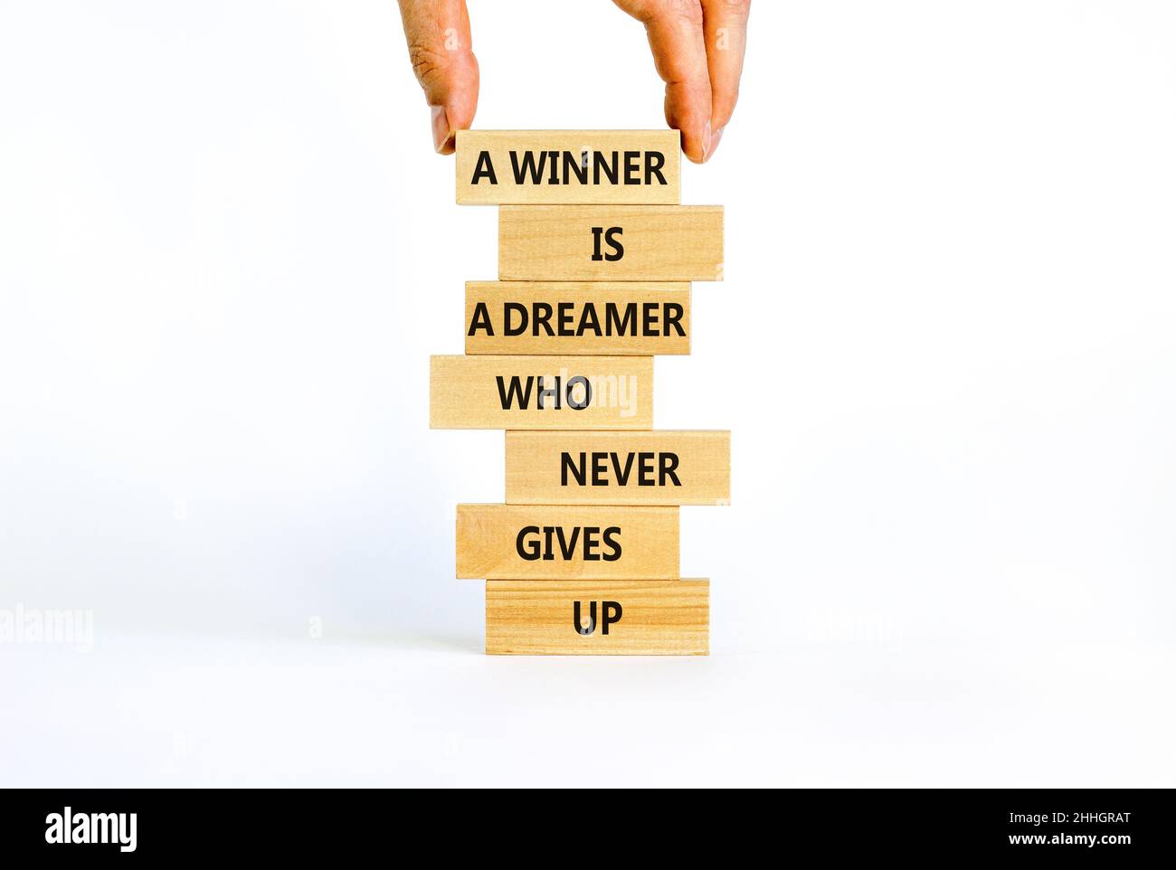 Winner or dreamer symbol. Wooden blocks with words A winner is a ...